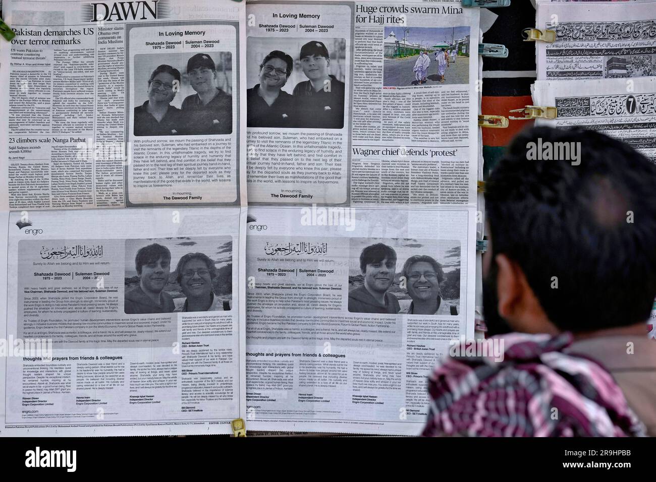 A man looks at morning newspapers as some papers published an ad of ...