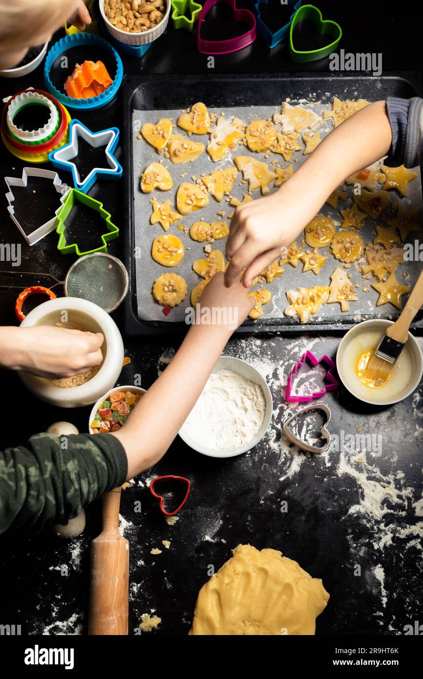 Making cookies by children. Cookies of different shapes are laid out on ...