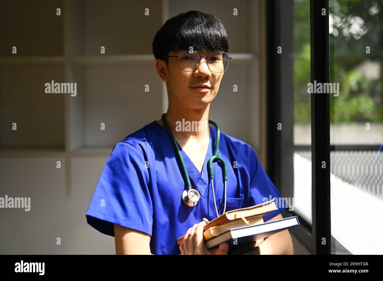 Young male medical students wearing blue scrubs with stethoscope ...