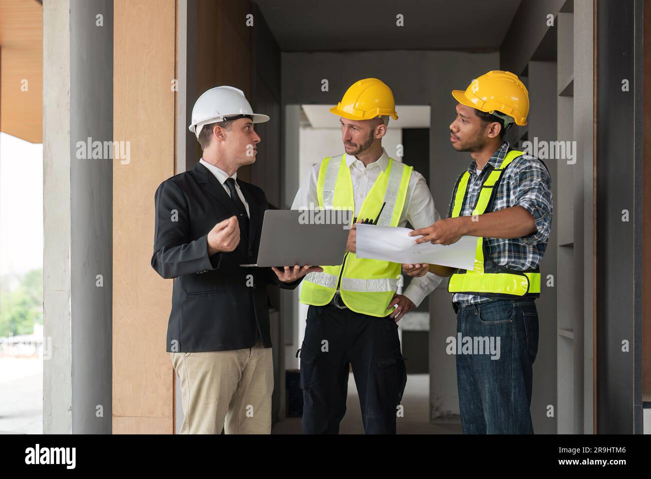 Professional construction engineers team using blueprint of project ...