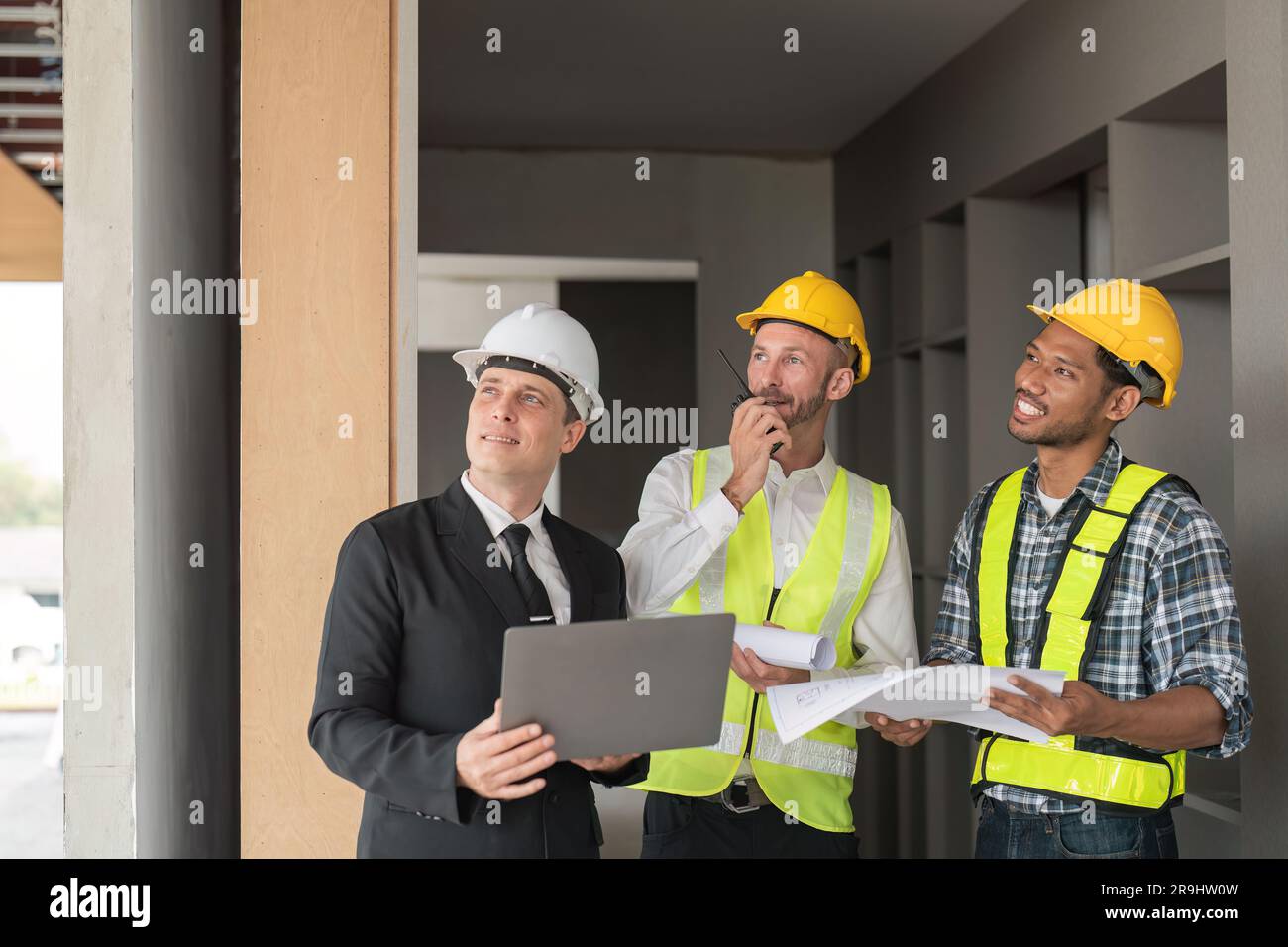 Professional construction engineers team using blueprint of project ...