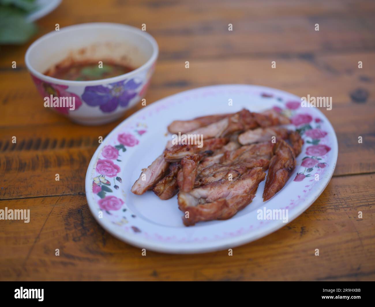 Grilled Beef with Spicy Jaew Dip in THAI street food Stock Photo - Alamy