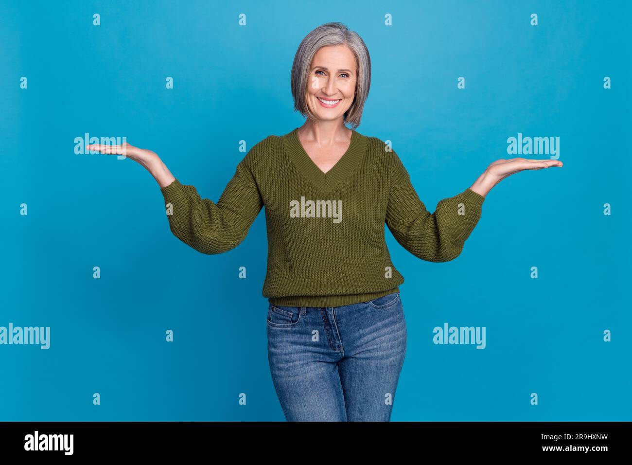 Photo of attractive senior woman hold open palms compare two new beauty ...
