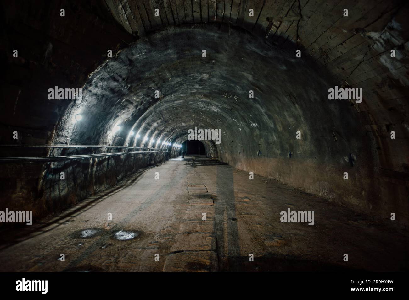 Dark large tunnel at old underground bunker Stock Photo - Alamy