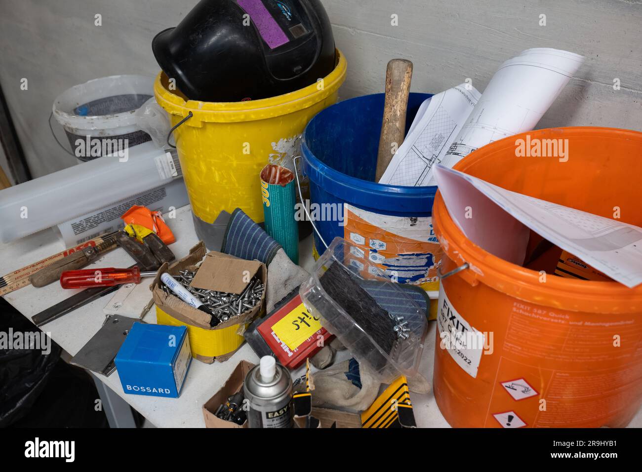 House renovator's messy work station with paint buckets and builder's ...