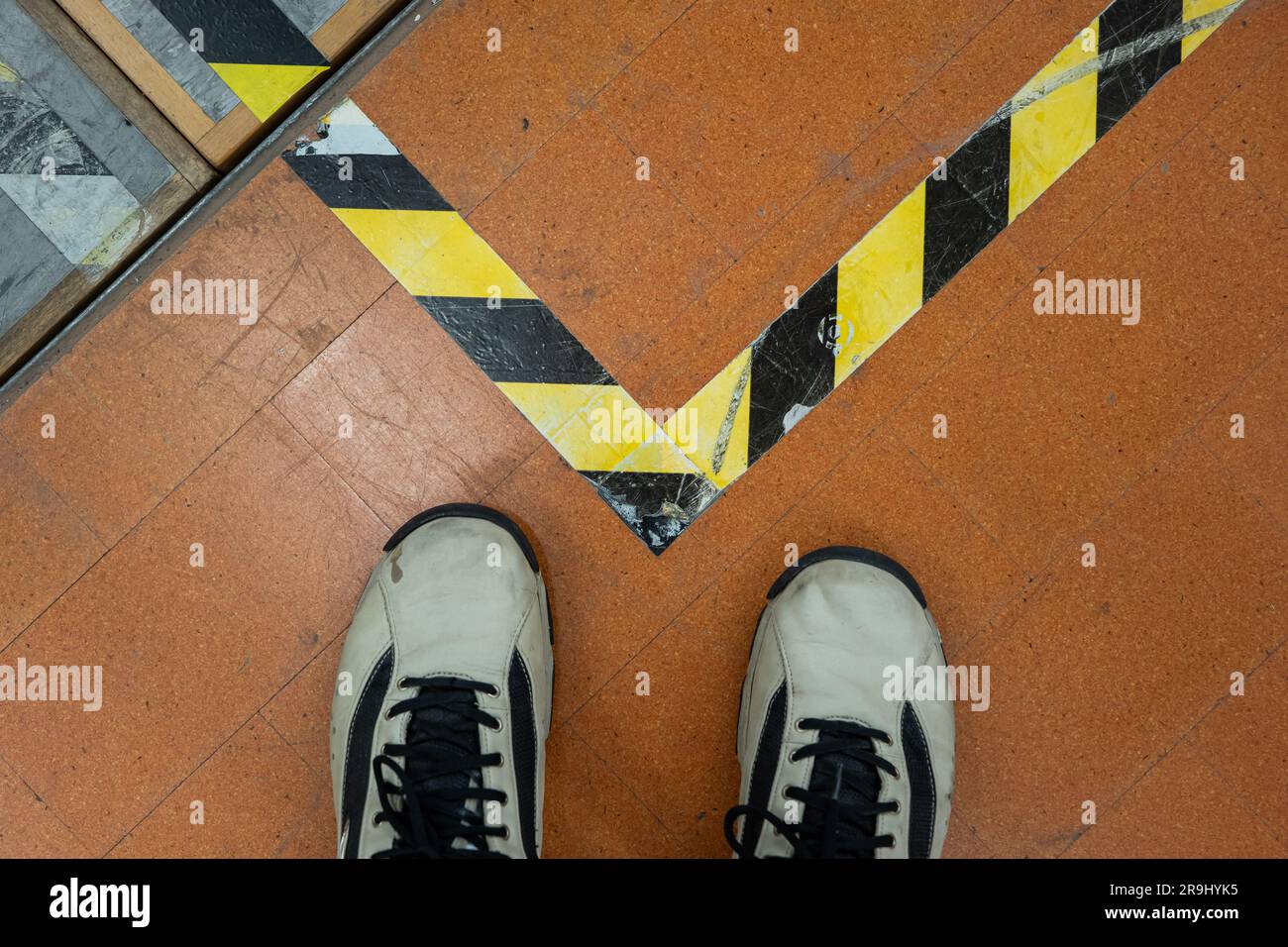 Male feet in shoes standing close to a no trespassing security tape on ...