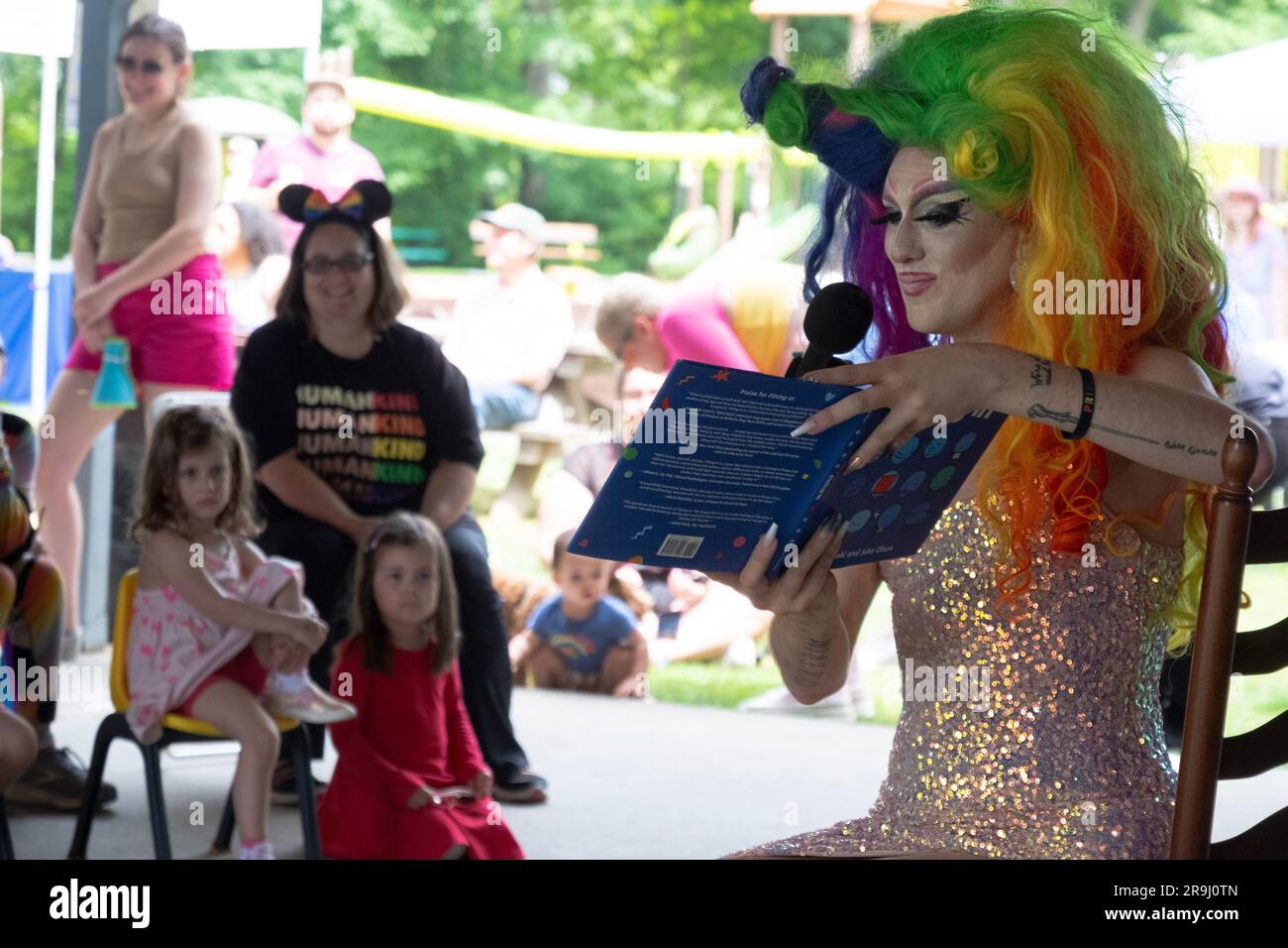 A drag performer reads a book to Children called Fitting In, about ...