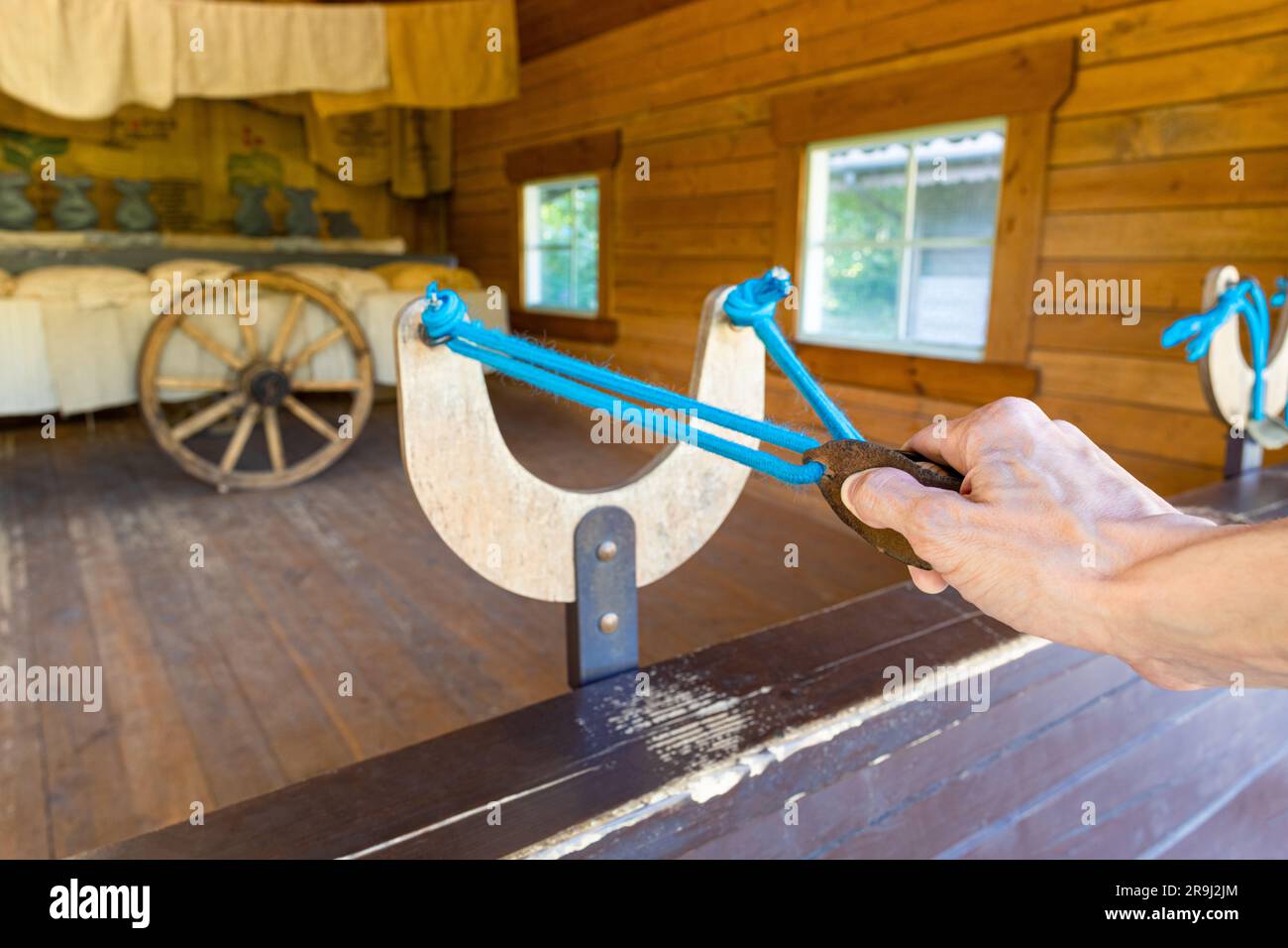 a man in a shooting range shoots a slingshot. target shooting Stock ...