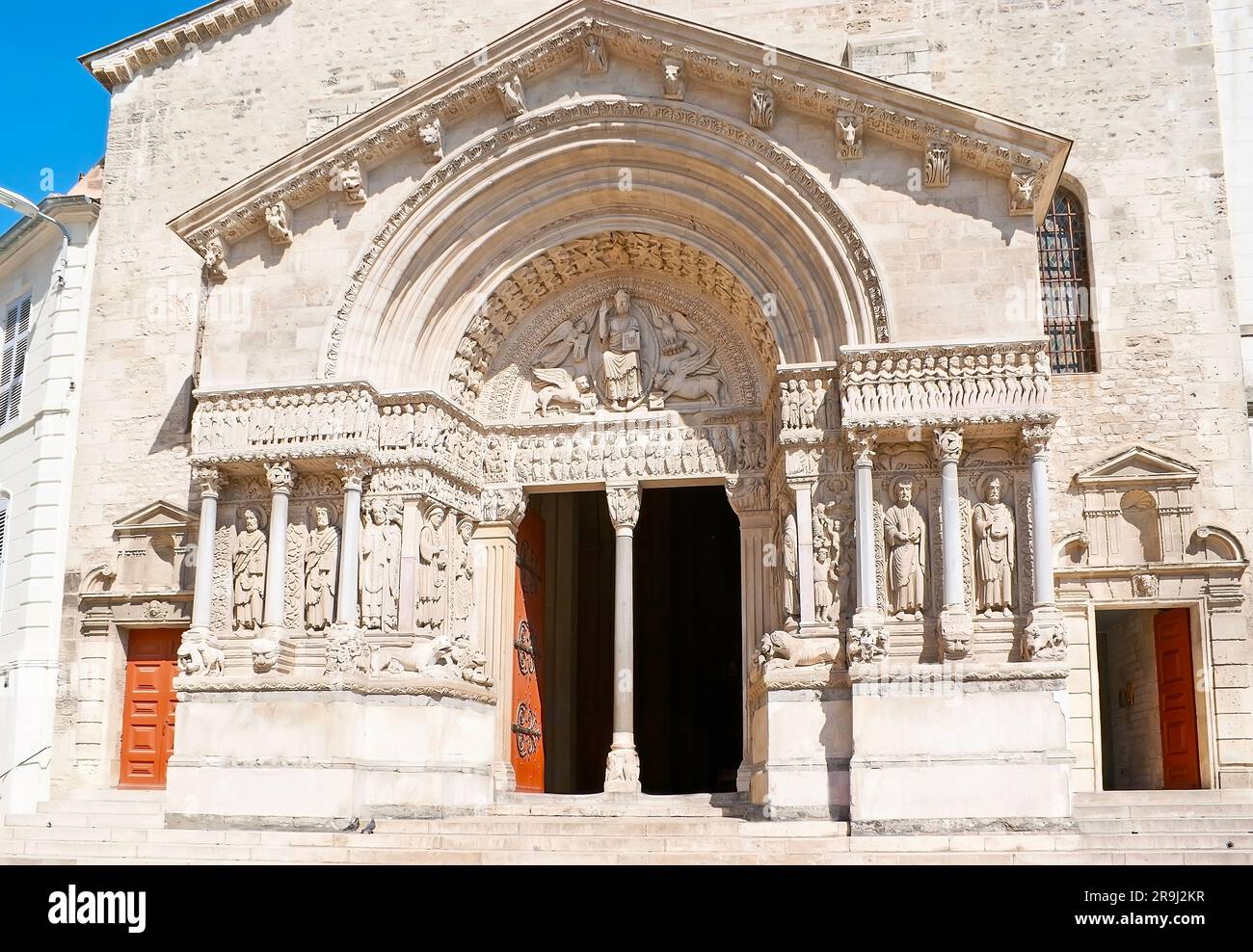 The ornate Romanesque gate of the medieval St Trophime Cathedral with ...