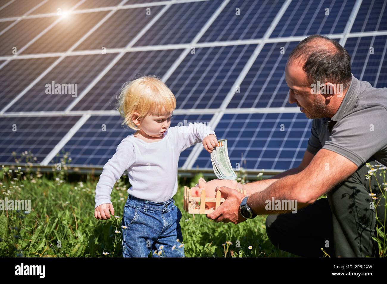 Father and son putting coin piggy bank hi-res stock photography and ...