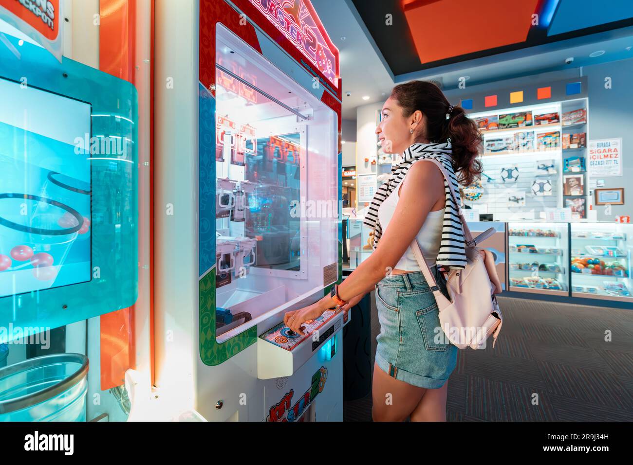 25 August 2023, Antalya, Turkey: Girl playing arcade games in the ...