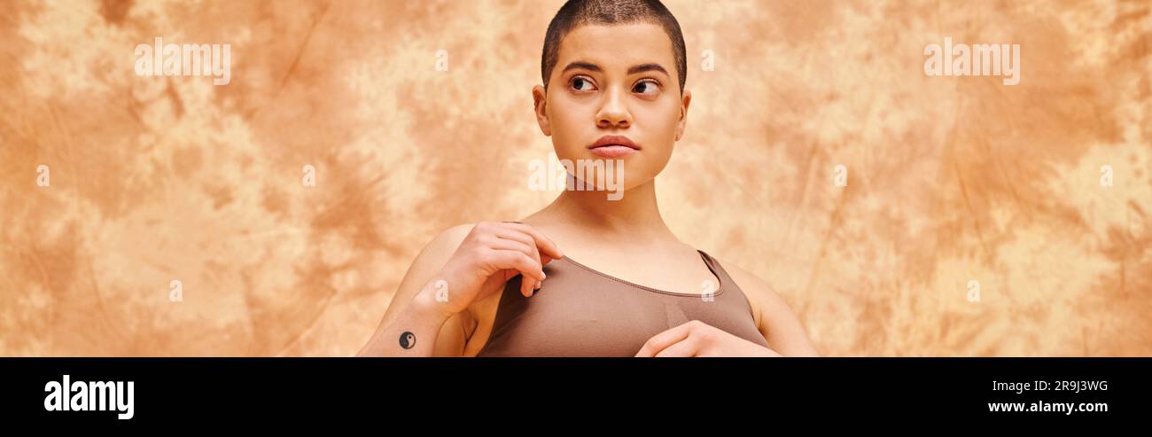 body positivity movement, curvy and tattooed woman in crop top posing ...