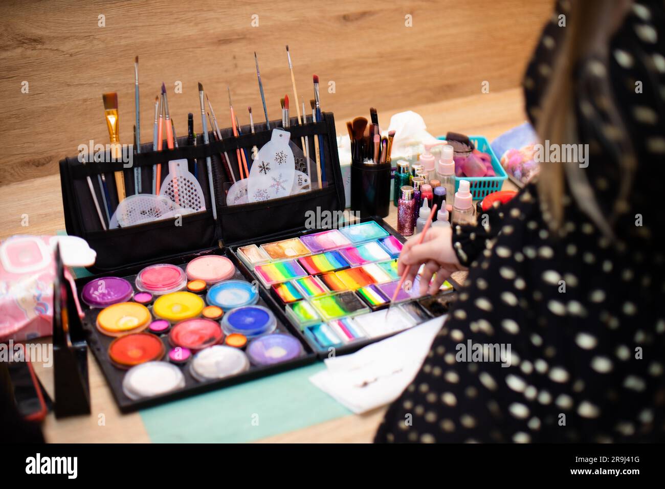 Colourful paint boxes and tubes with paints on a table. Paints and ...