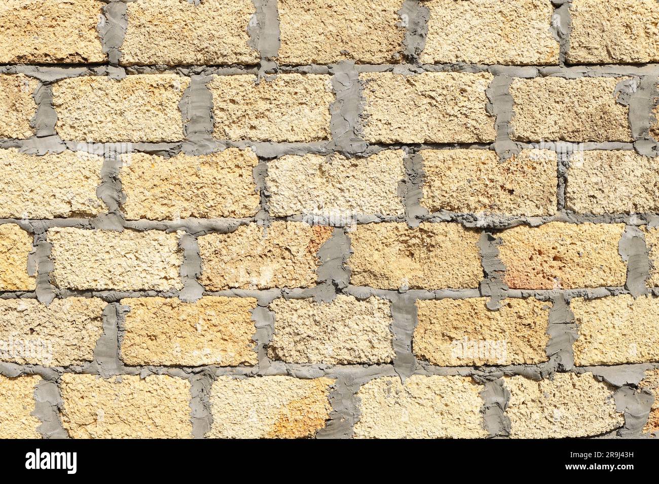 Stone bricks from limestone laid by a wall and by cement. Background ...