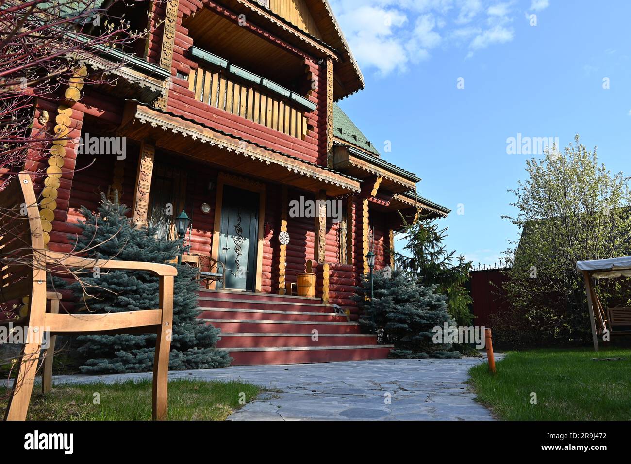 tall wooden house with lawn and porch Stock Photo - Alamy