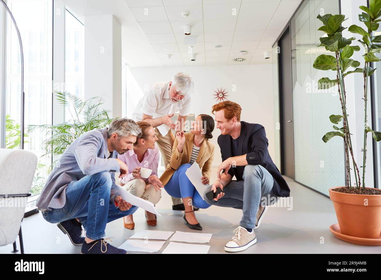 Brainstorming five colleagues discussing hi-res stock photography and ...