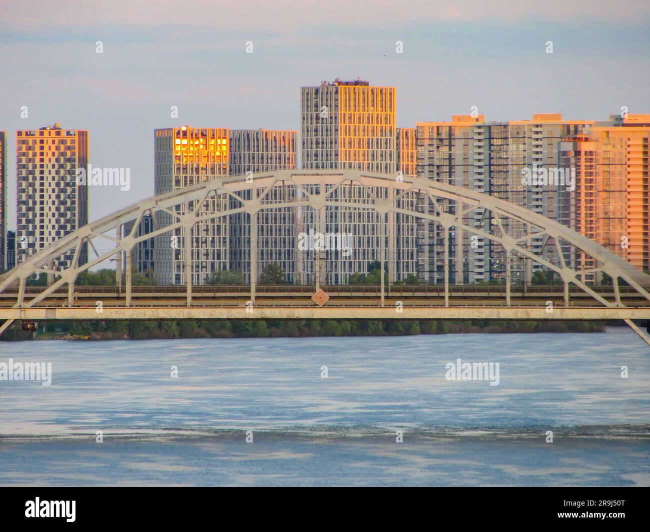 Arc Bridge Over the River with modern city building at Sunset With Copy ...