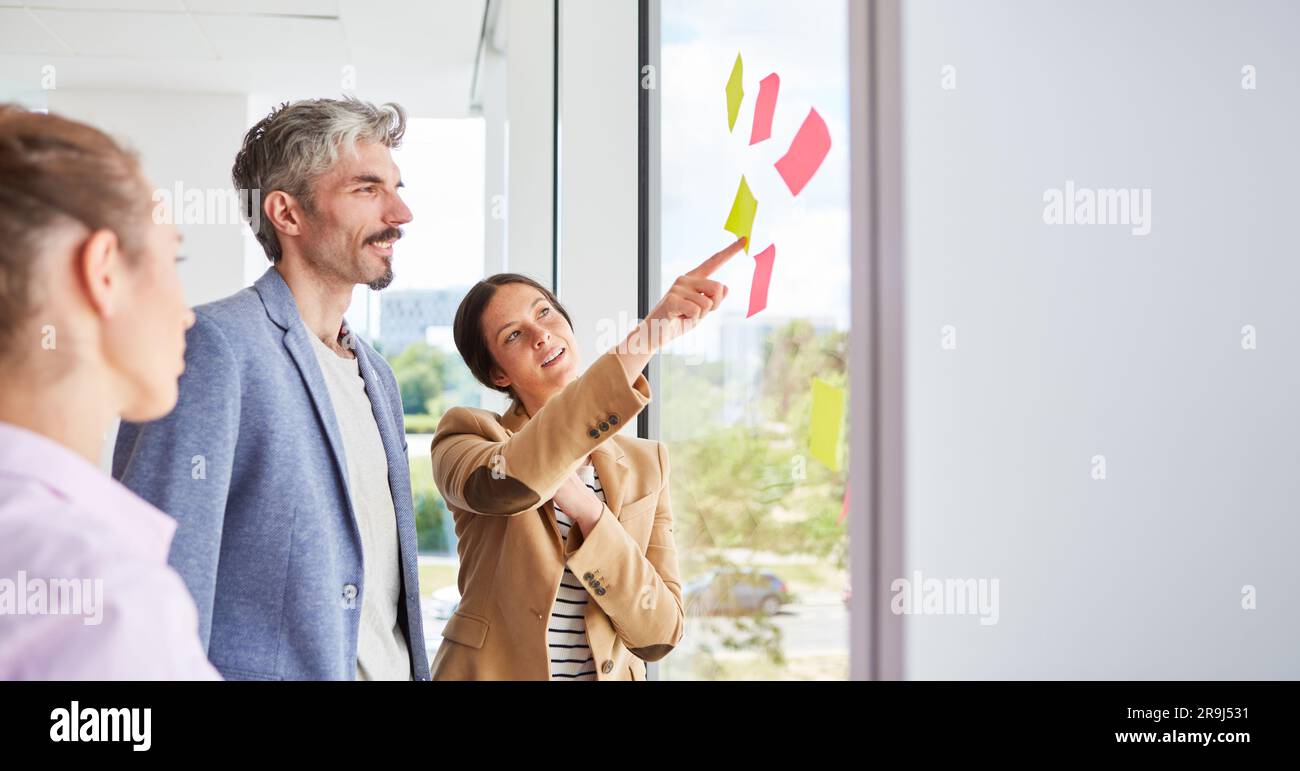Happy three colleagues planning hi-res stock photography and images - Alamy