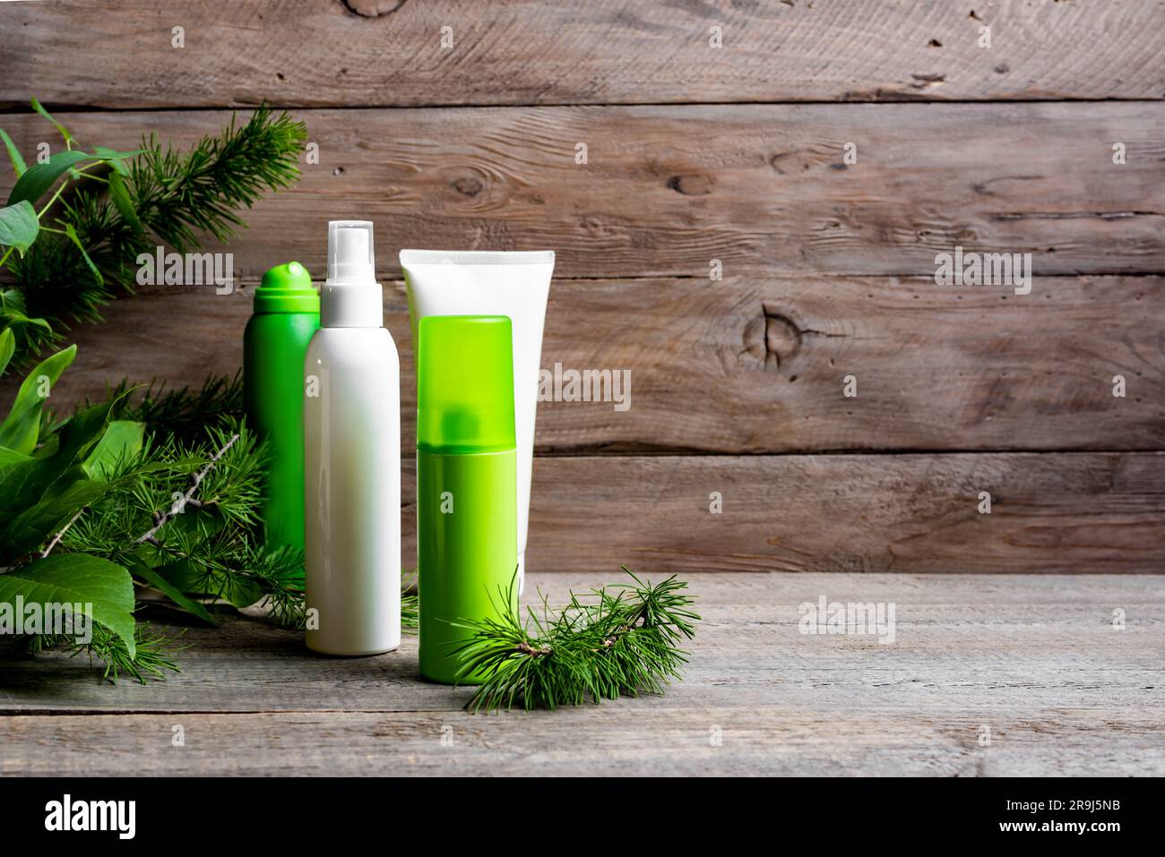 Mosquito repellents and sprays anti stinging insects on wooden ...