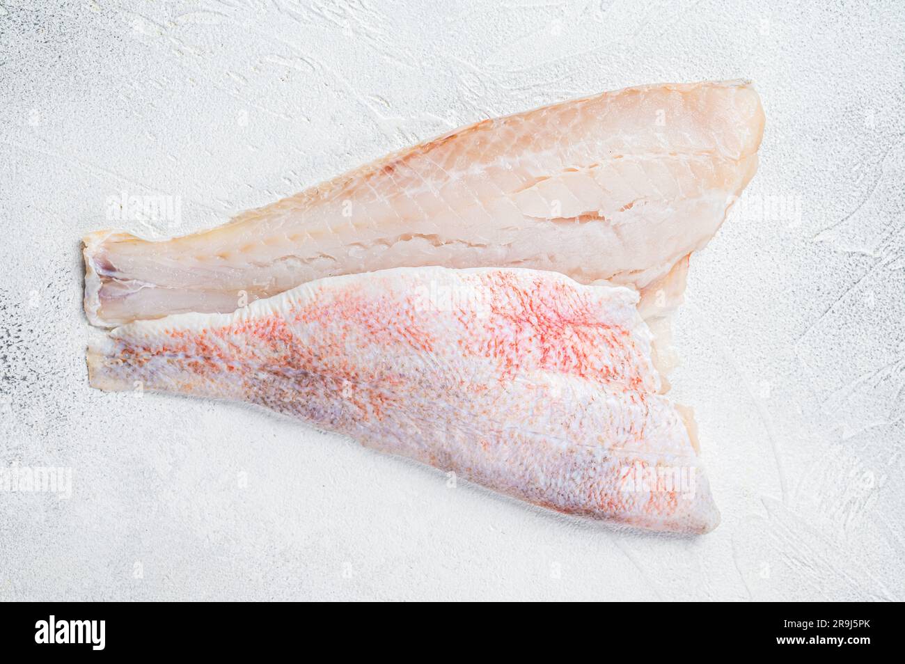 Raw red perch fillet, redfish fish meat. White background. Top view ...