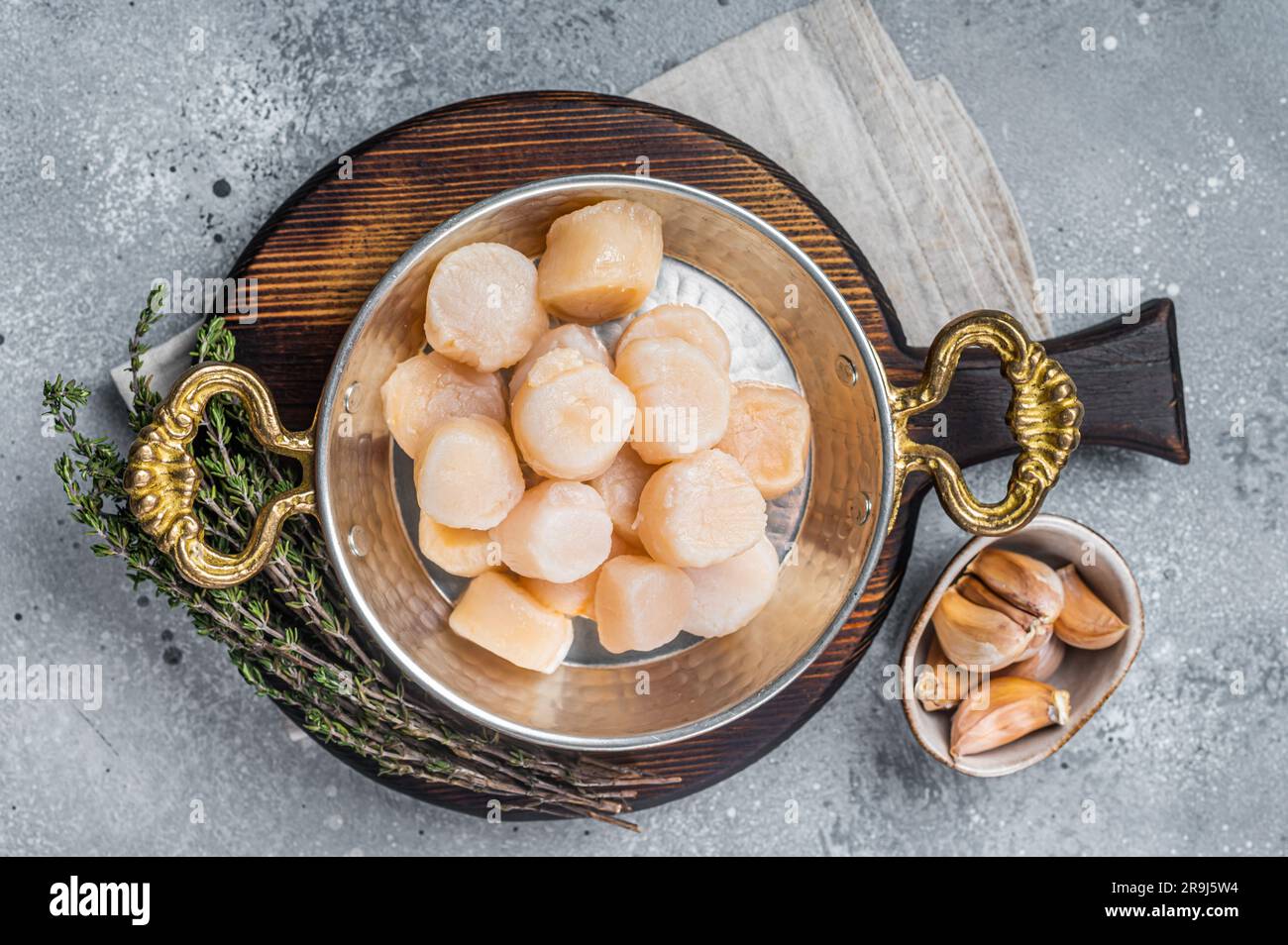 Raw sea scallops fillets in a skillet. Gray background. Top view Stock ...