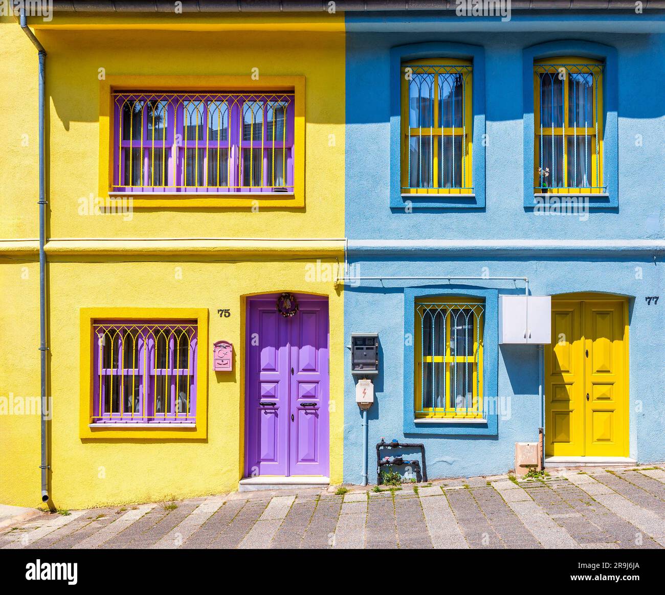 Exterior facade of colorful twin houses with walls painted in vivid ...
