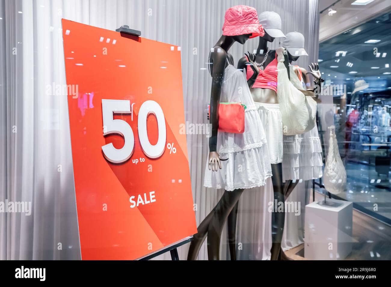 50 percent sale at the window of a fashion store or boutique with ...