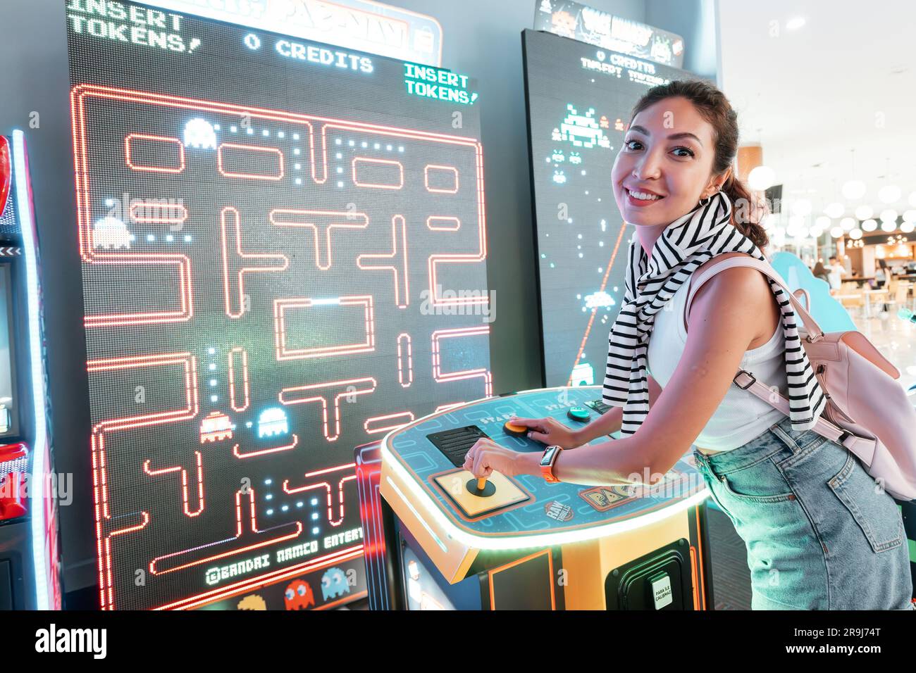 25 August 2023, Antalya, Turkey: Girl playing arcade video games in the ...