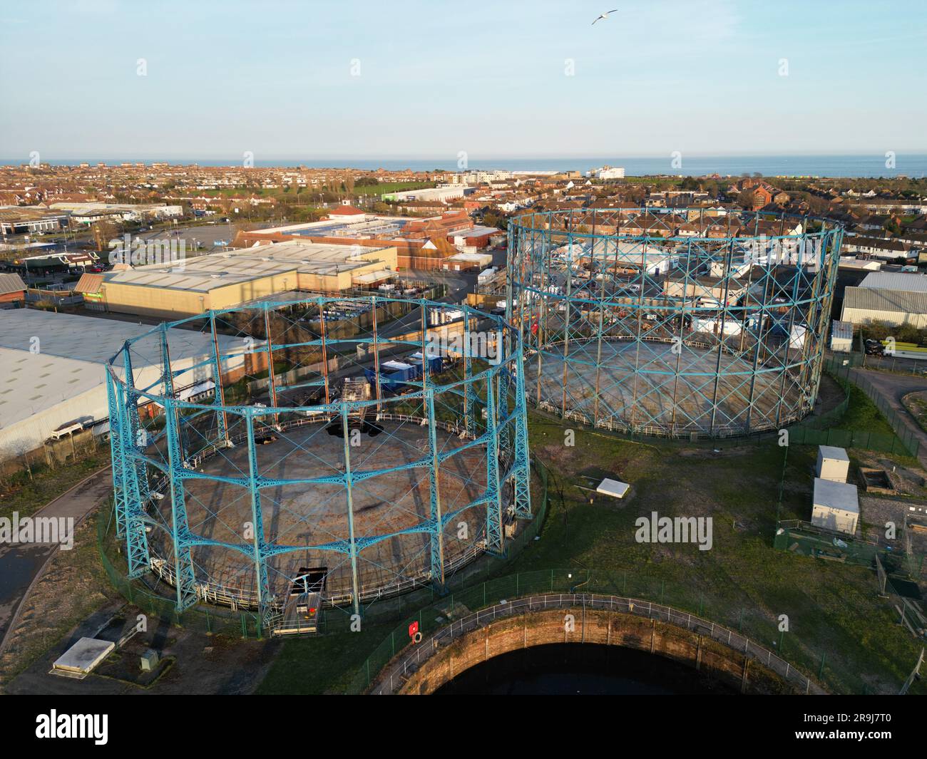 An aerial view of a column-guided gas holder surrounded by industrial ...