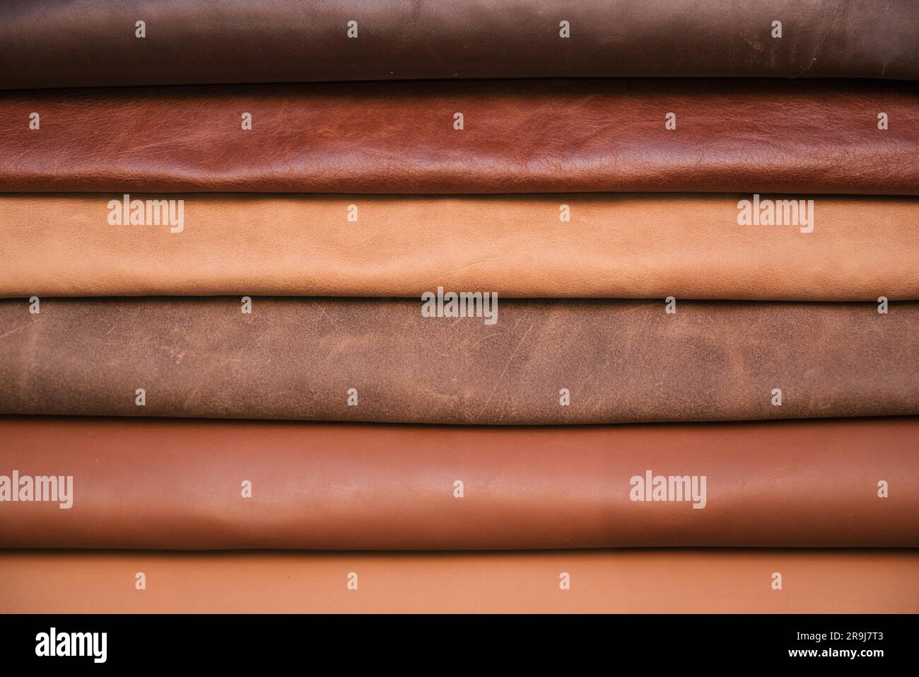 An array of leather fabric samples in different shades neatly placed on ...