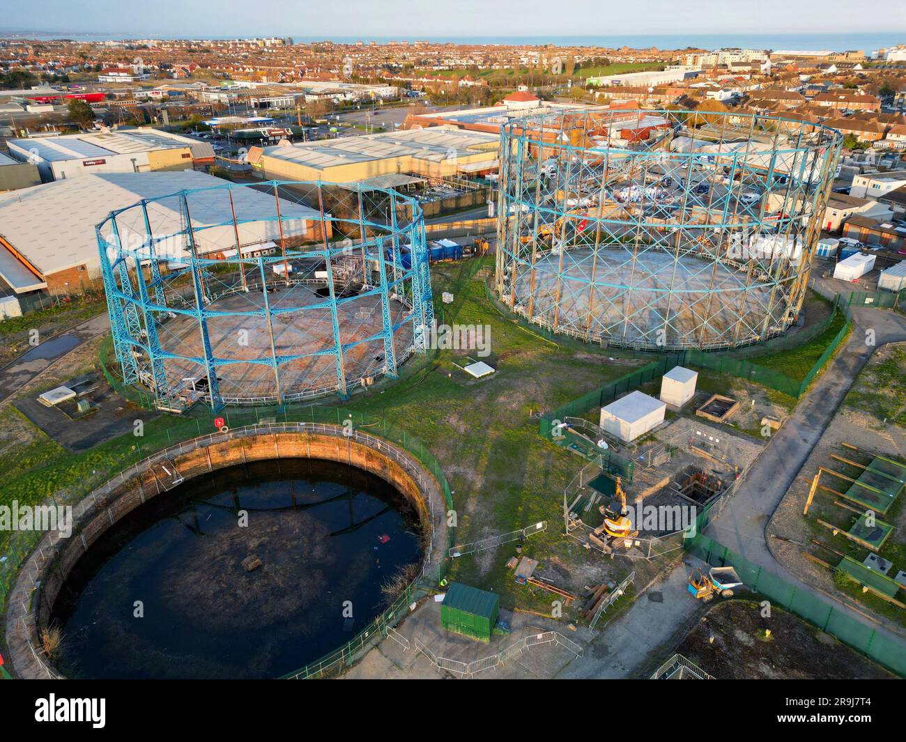 An aerial view of a column-guided gas holder surrounded by industrial ...