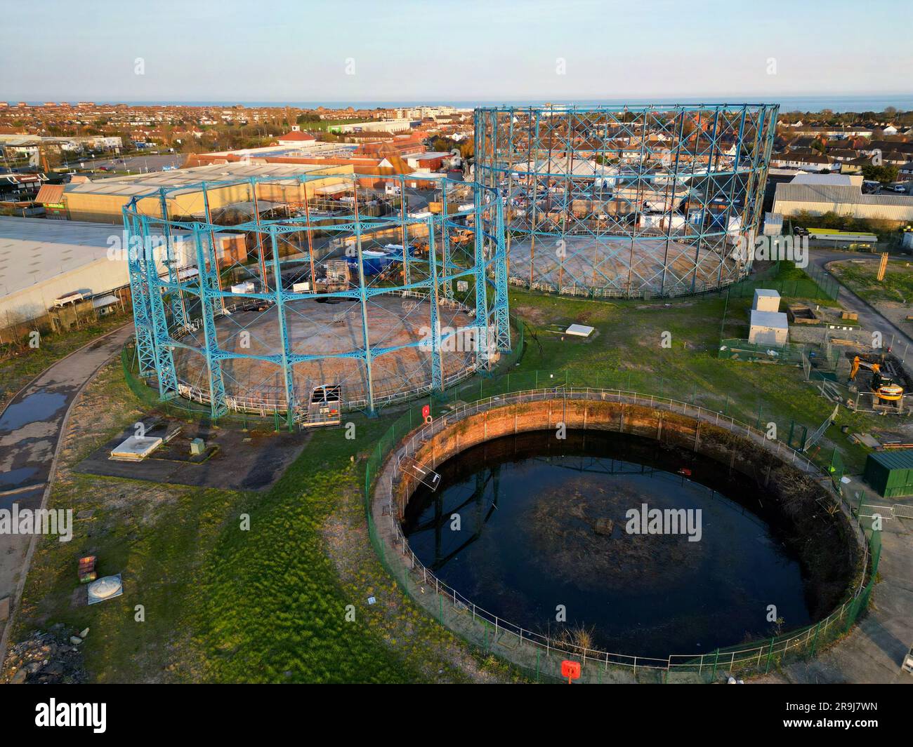 An aerial view of a column-guided gas holder surrounded by industrial ...