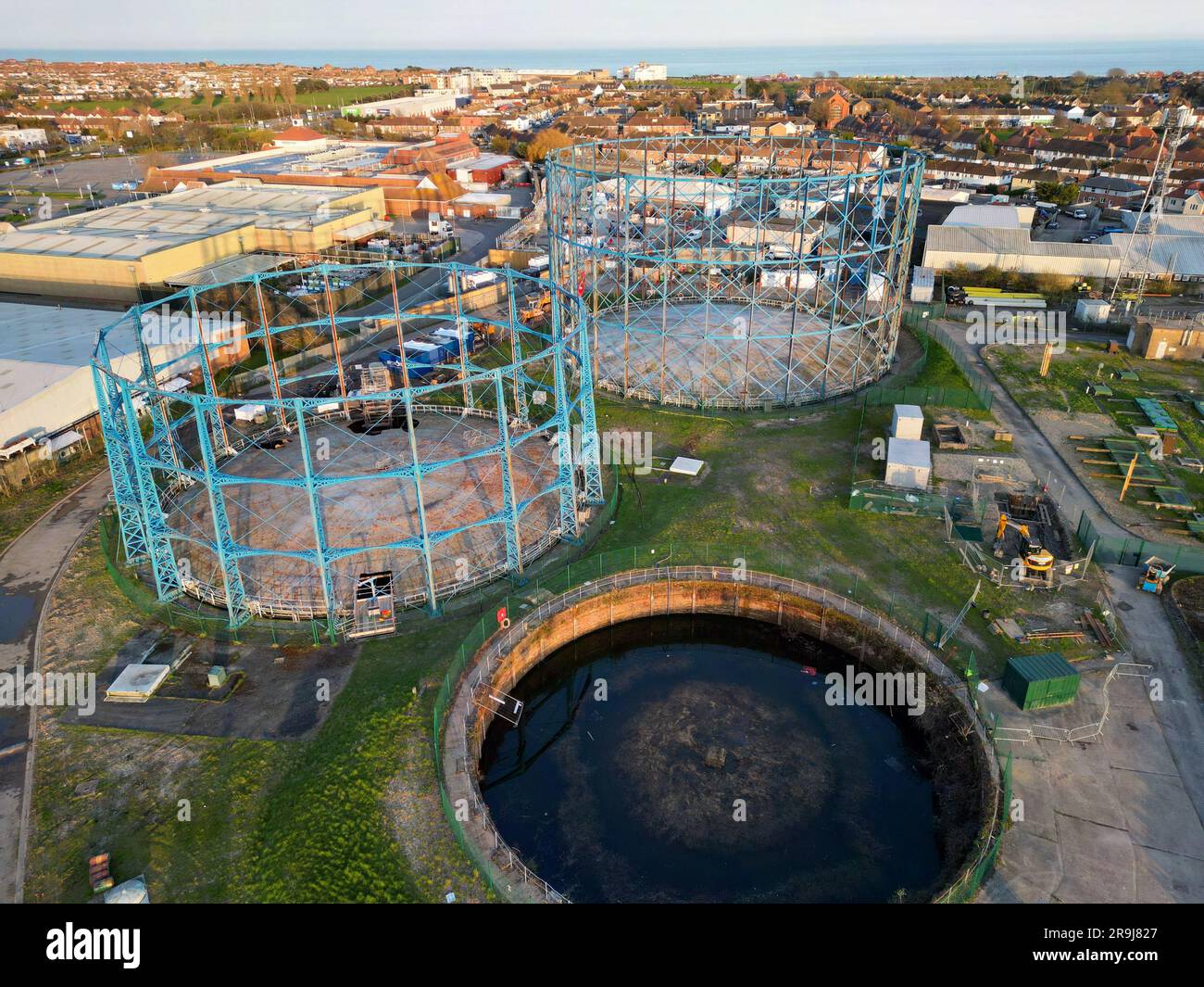 An aerial view of a column-guided gas holder surrounded by industrial ...