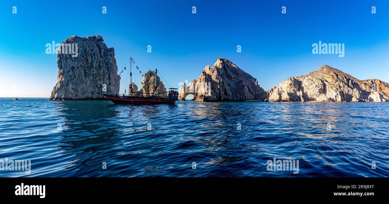Panoramic view of the arch of Cabo San Lucas and a pirate ship plying ...