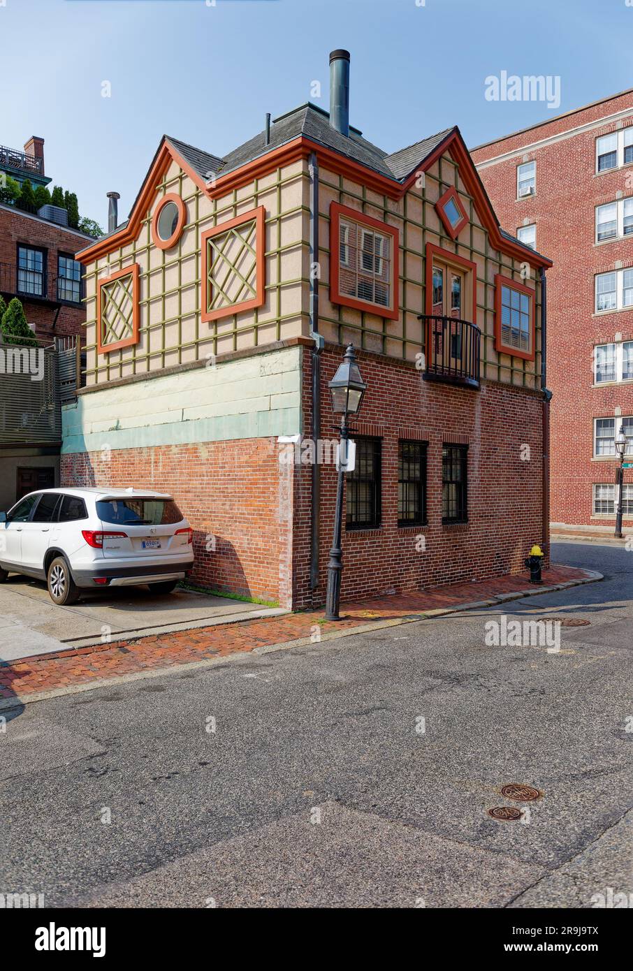 Green lattice and red window surrounds float on the stucco walls of ...