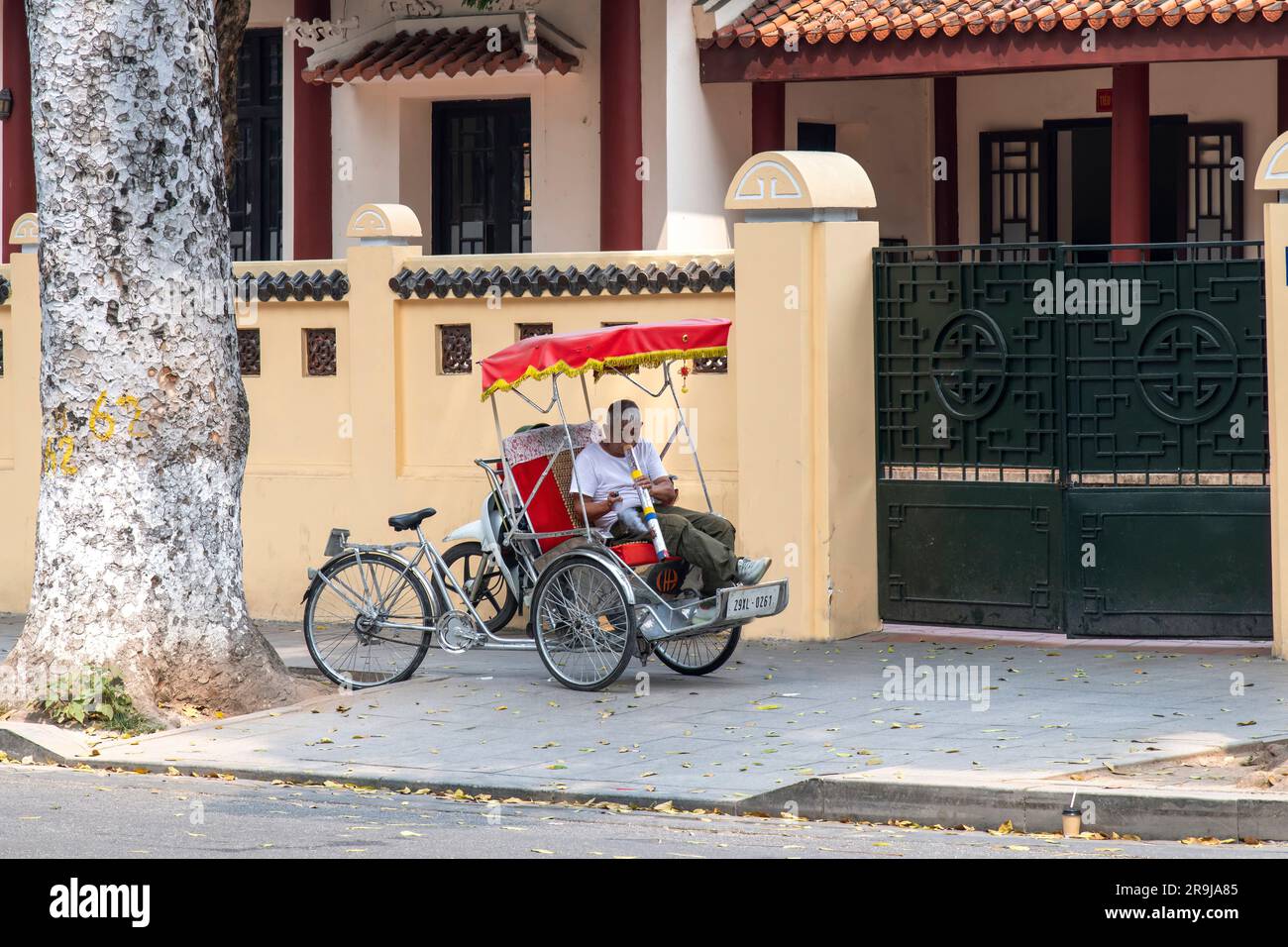Hanoi, Vietnam-April 2023; View of a man sitting in his bicycle ...