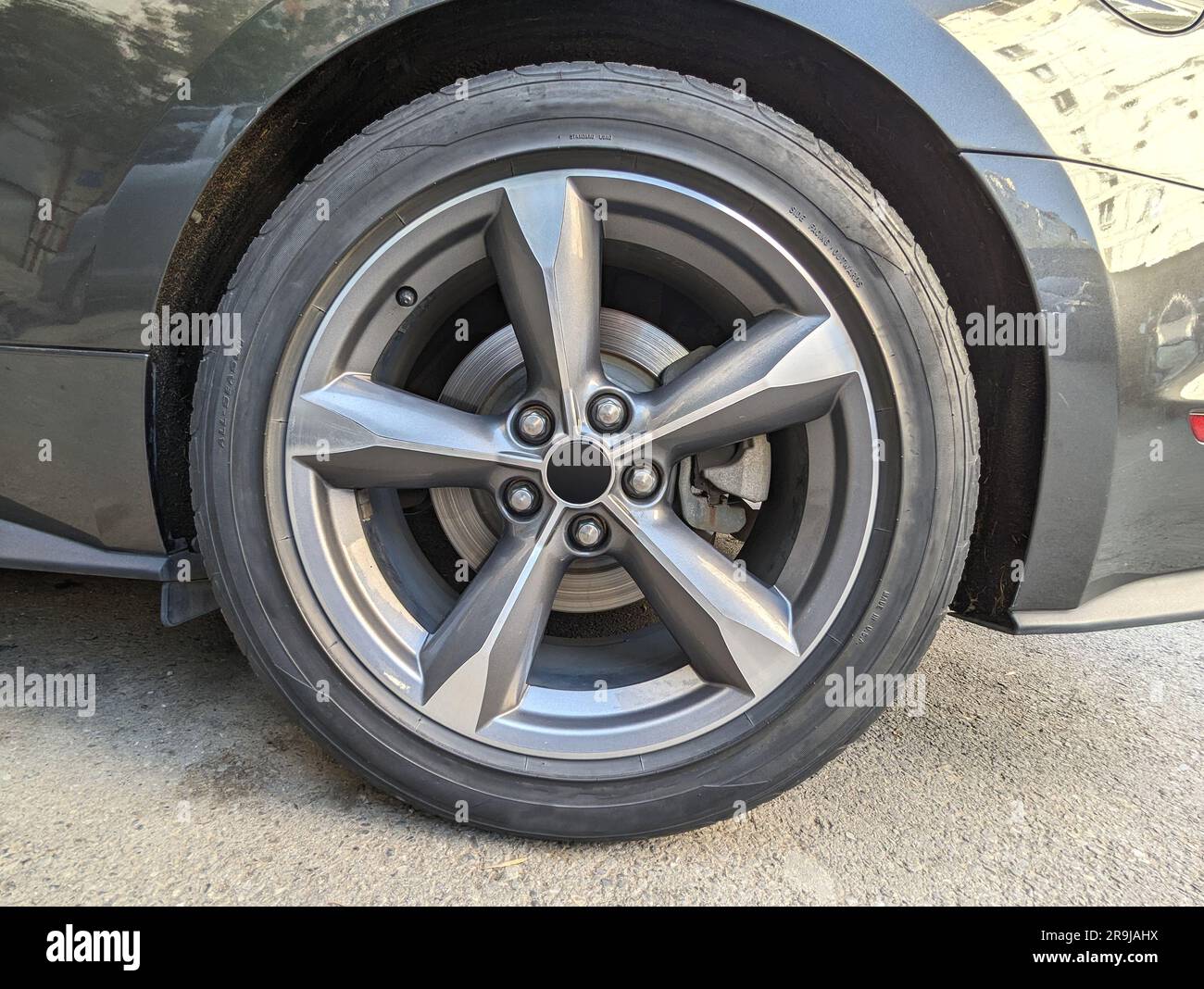close up of used car wheel disk. scratch and dirty aluminium wheel rim ...