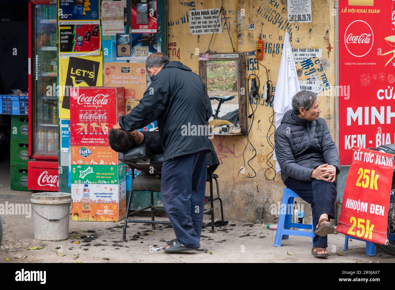 Hanoi, Vietnam-April 2023; Close up of a barber giving a shave to a men ...