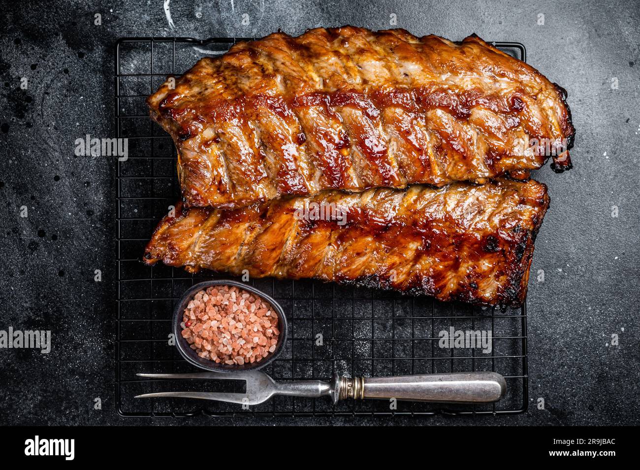 BBQ grilled pork spare ribs on a rack. Black background. Top view Stock ...