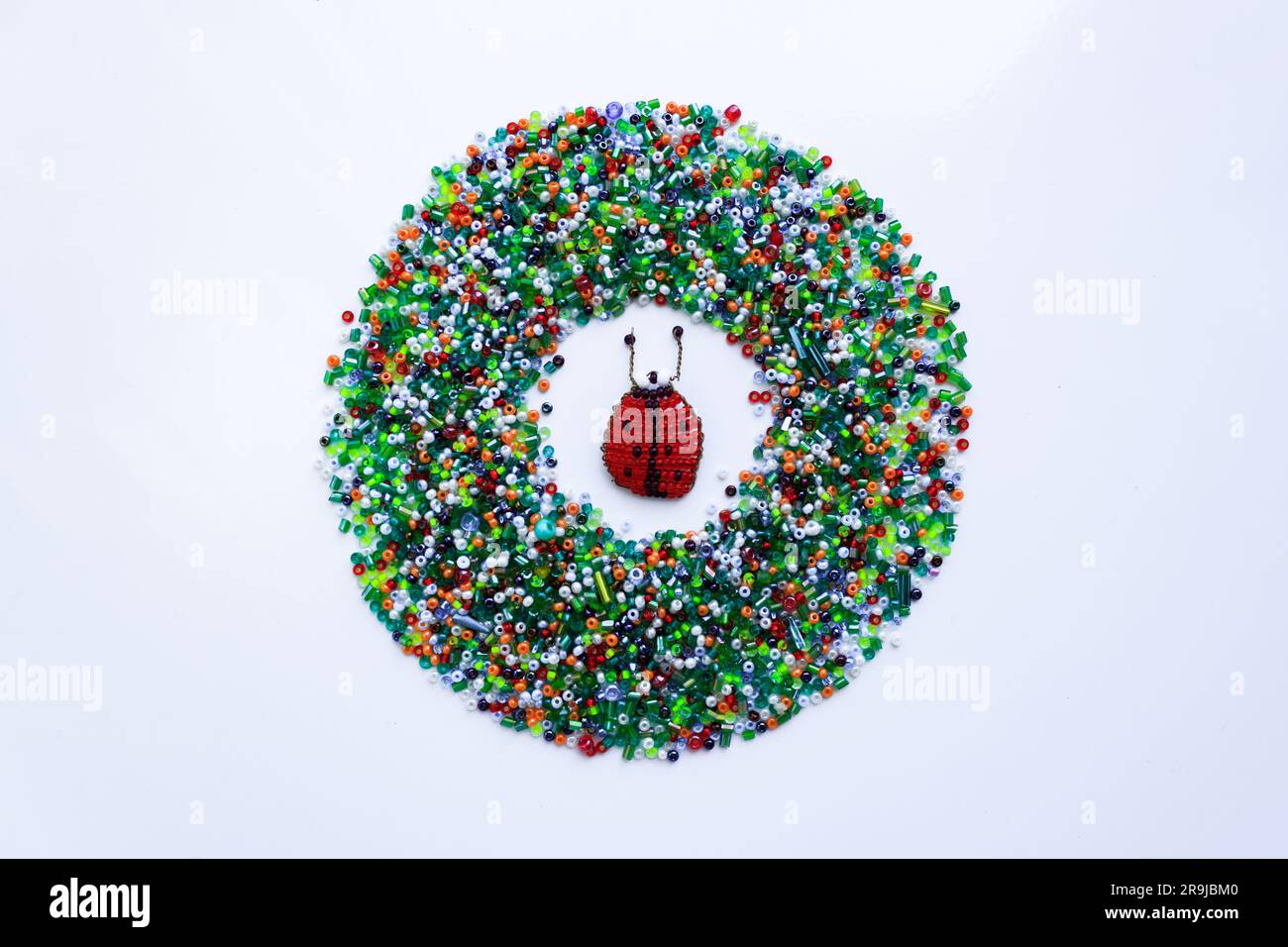 On a white background, a pattern of small colored beads in the form of ...