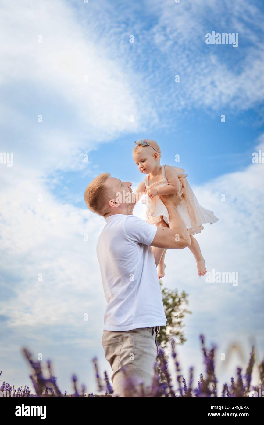 father lifts his daughter Stock Photo - Alamy