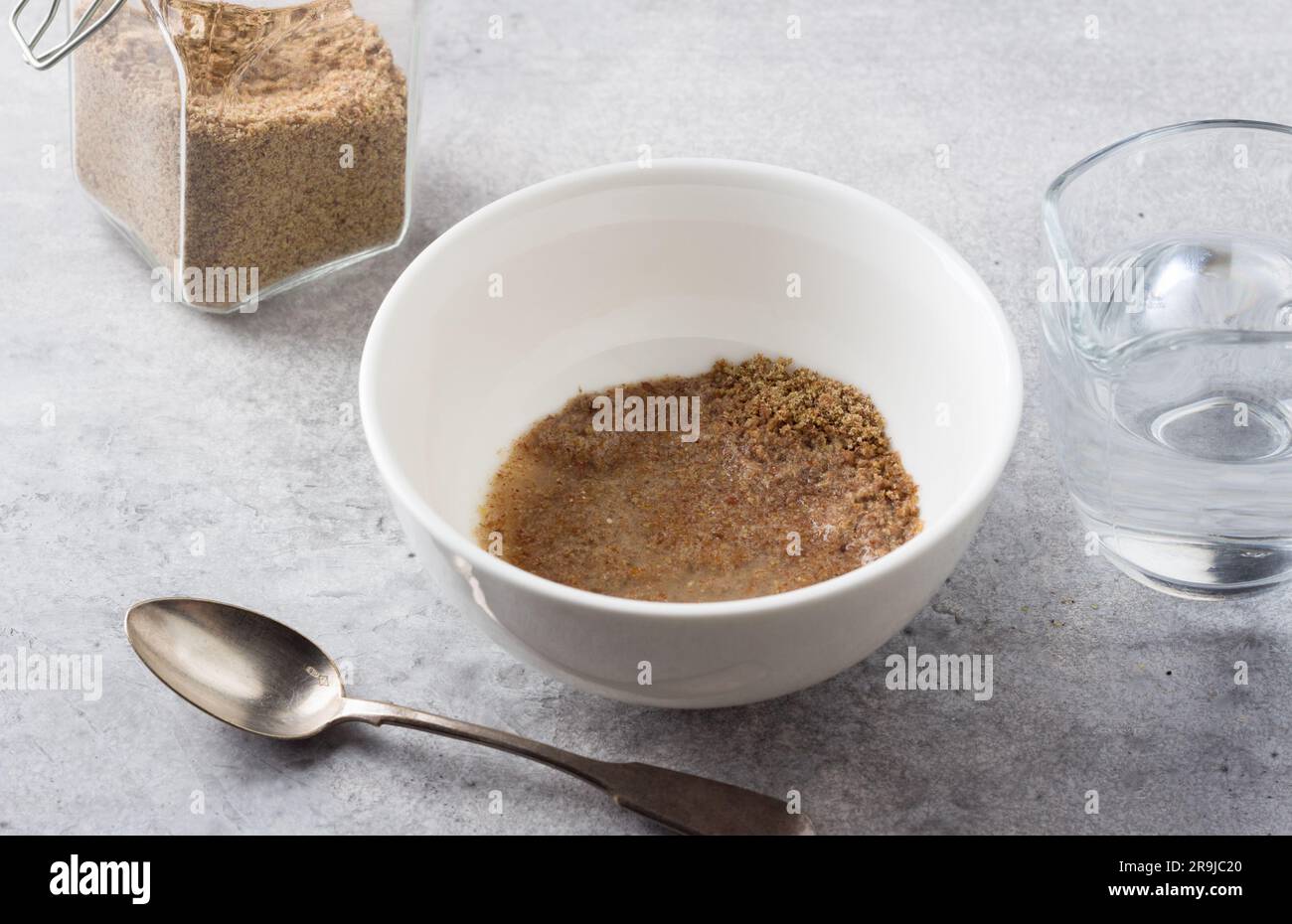 A bowl with ground flax and water, a jar of ground flax and a jug of ...