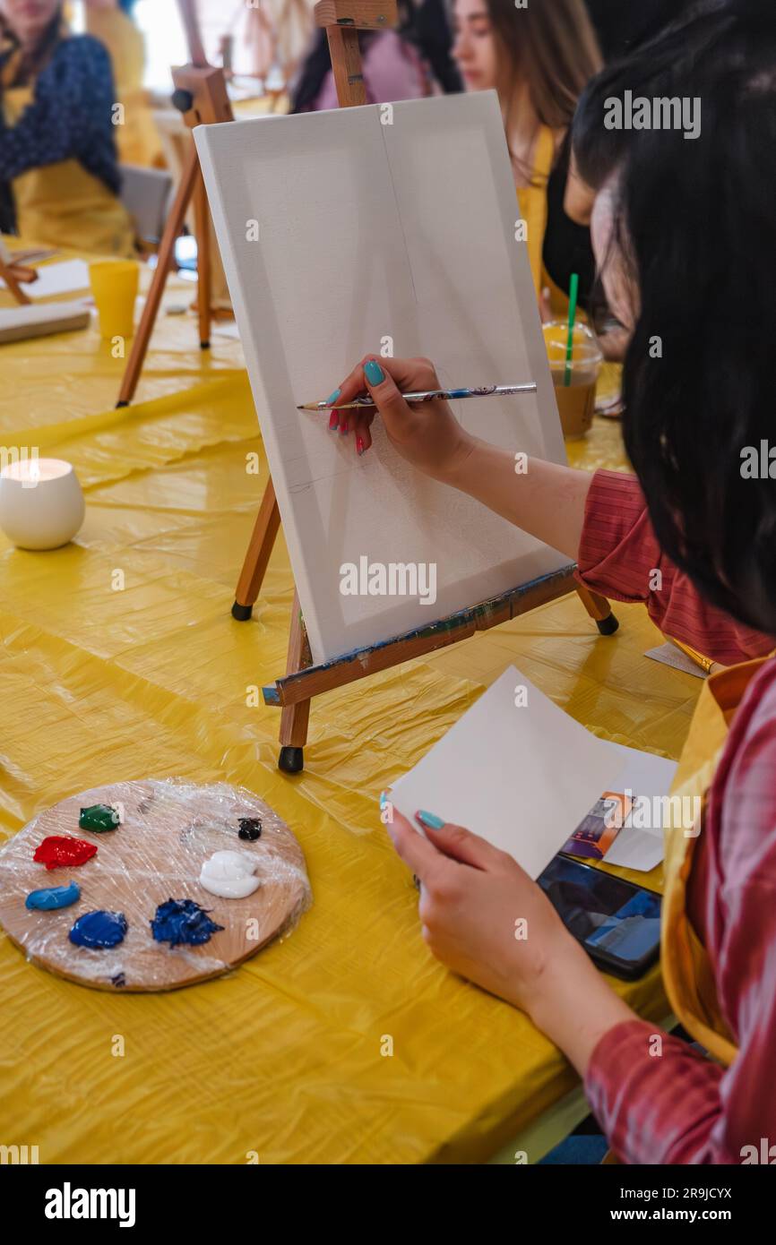 Art classroom women drawing painting pictures Stock Photo - Alamy