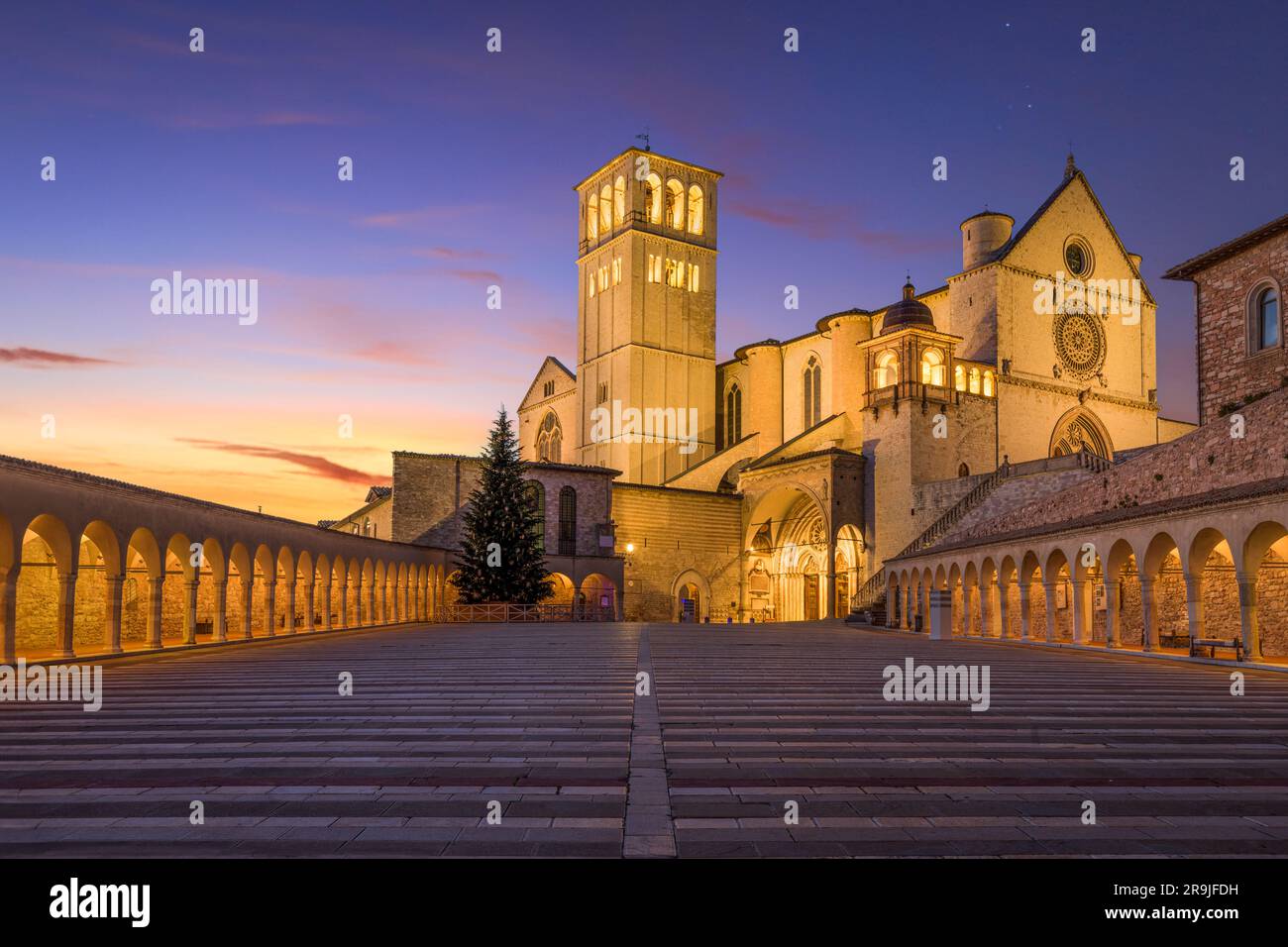 Assisi, Italy with the Basilica of Saint Francis of Assisi at dusk ...