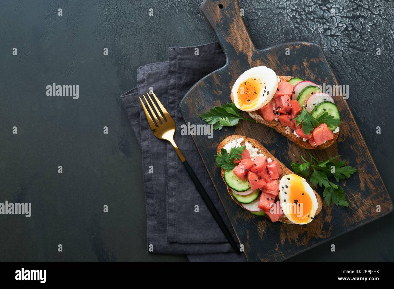 Healthy sandwich with bread or toast, smoked salmon, soft egg, cream ...