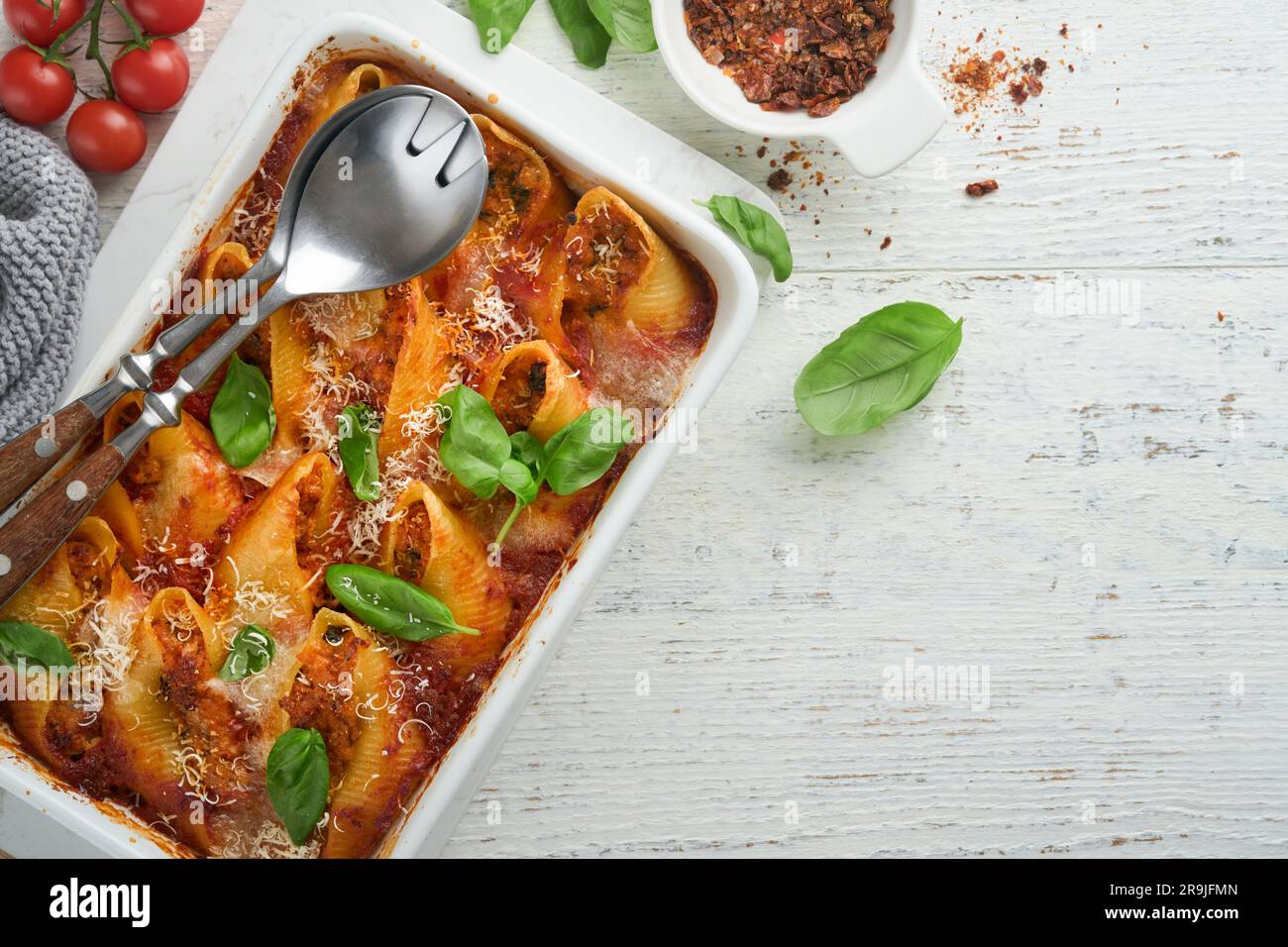 Cannelloni or conchiglioni. Baked stuffed pasta shells with bolognese ...
