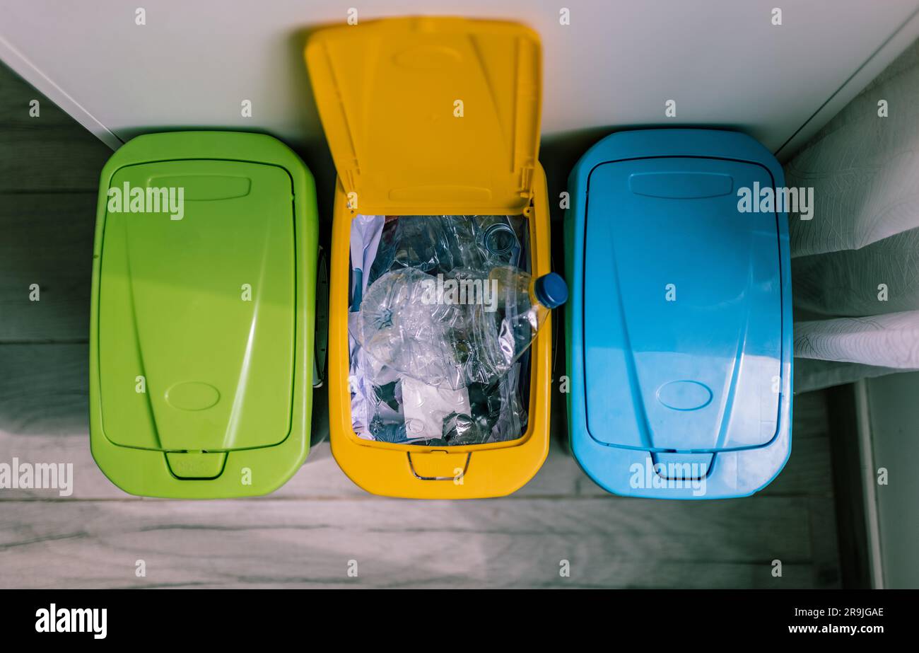 Top view of recycling containers and plastic bottles inside opened ...