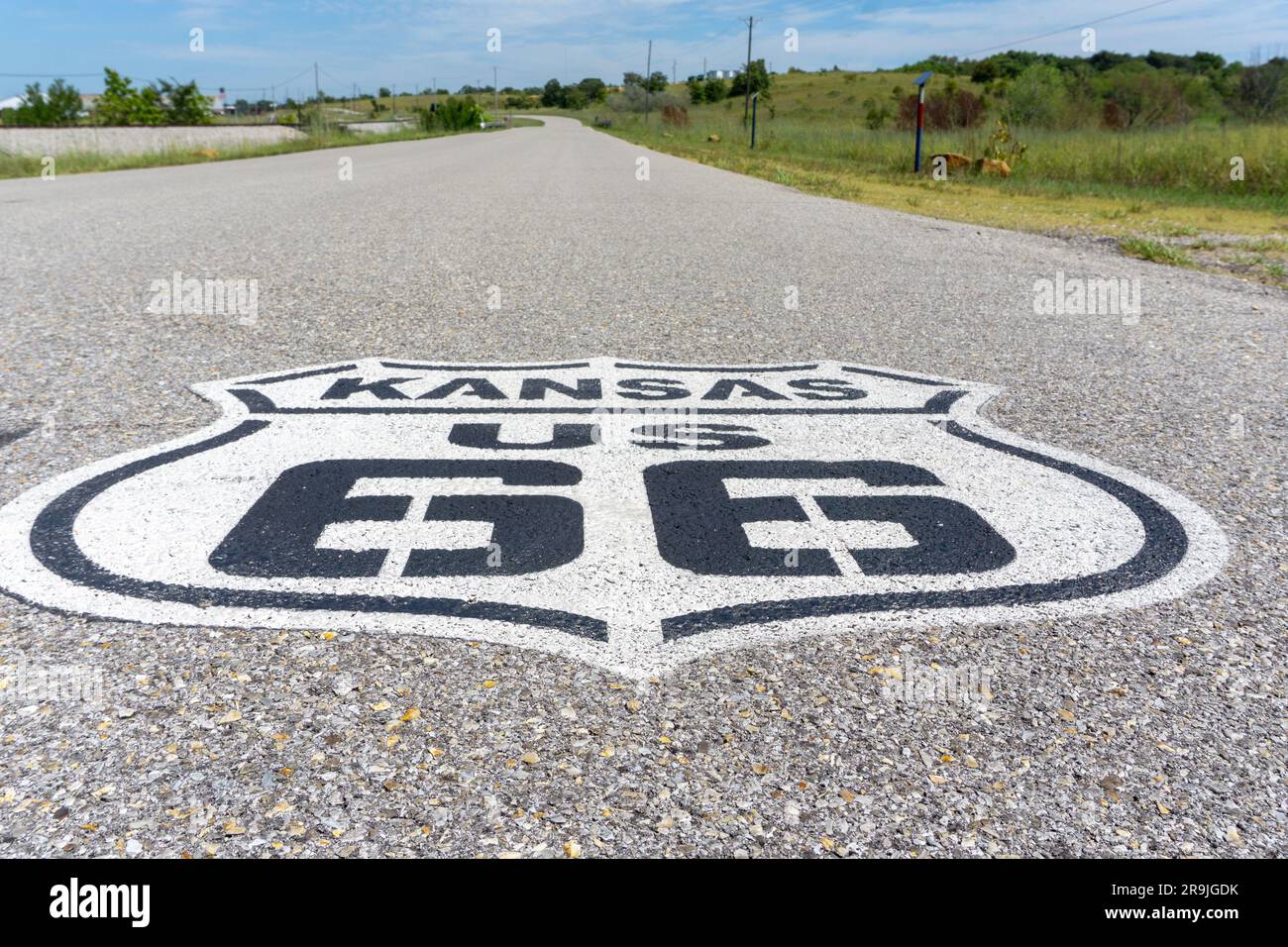 A vintage Kansas 66 highway sign painted on an asphalt highway in a ...