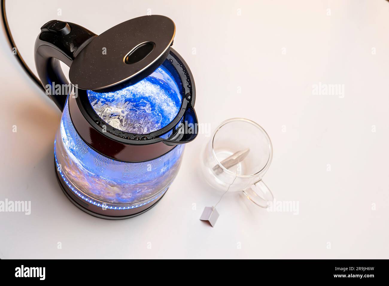 Brewing a tea bag. a fashionable tea cup with double glass walls and a ...