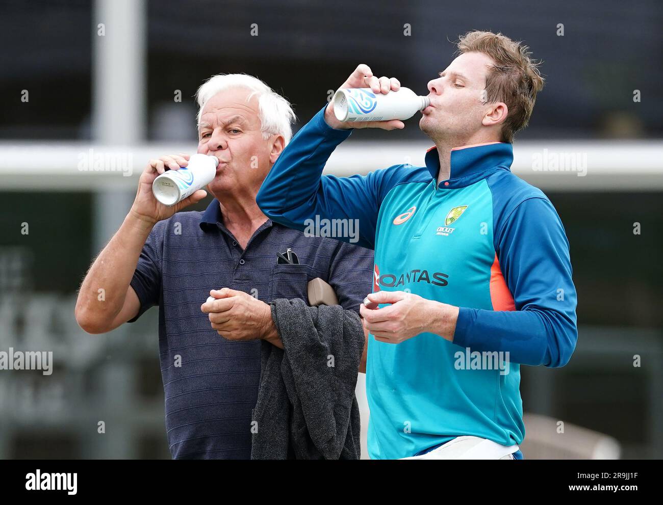 Australia's Steve Smith (right) and father Peter Smith have a drink ...